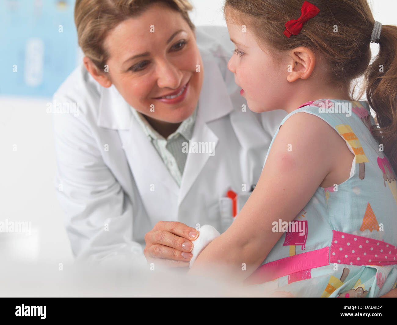 Paediatric doctor caring for a small girl in surgery Stock Photo - Alamy