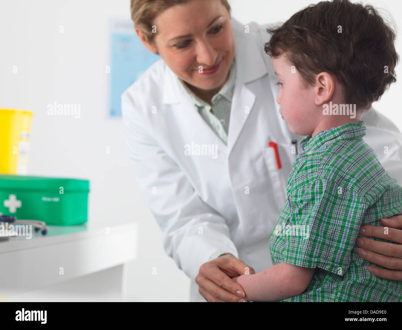 Doctor caring for small boy Stock Photo - Alamy