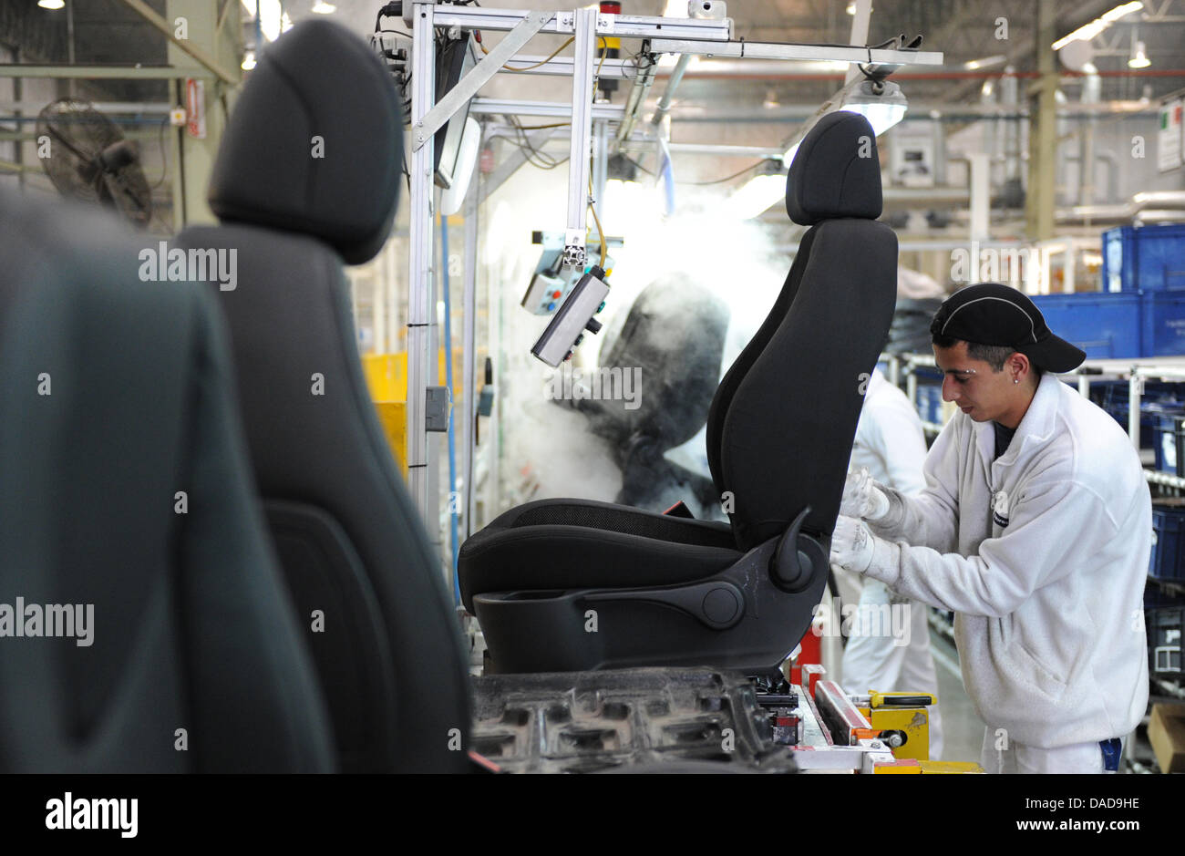 Employees assemble seats at the factory of car parts supplier Faurecia ...