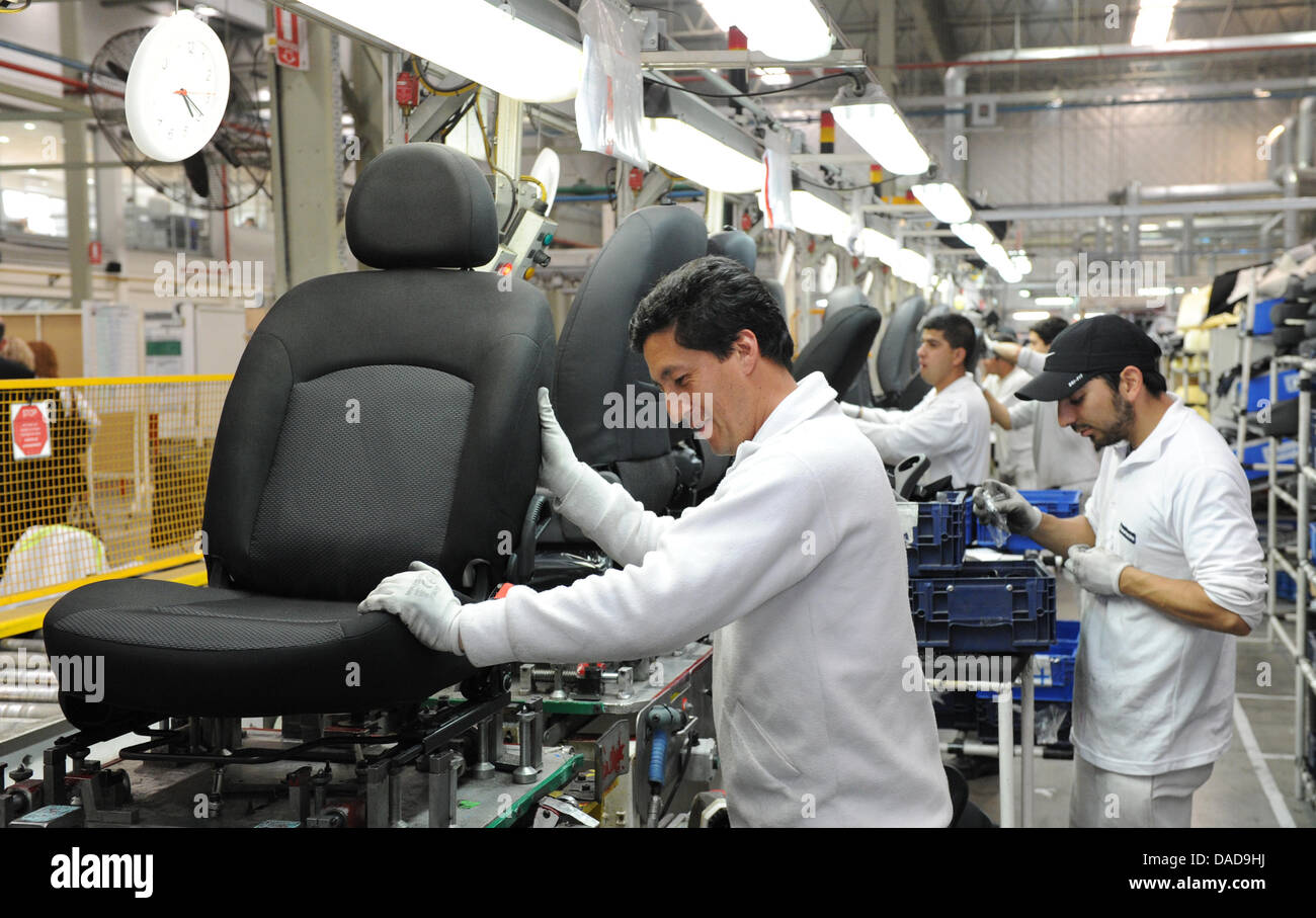 Employees assemble seats at the factory of car parts supplier Faurecia ...