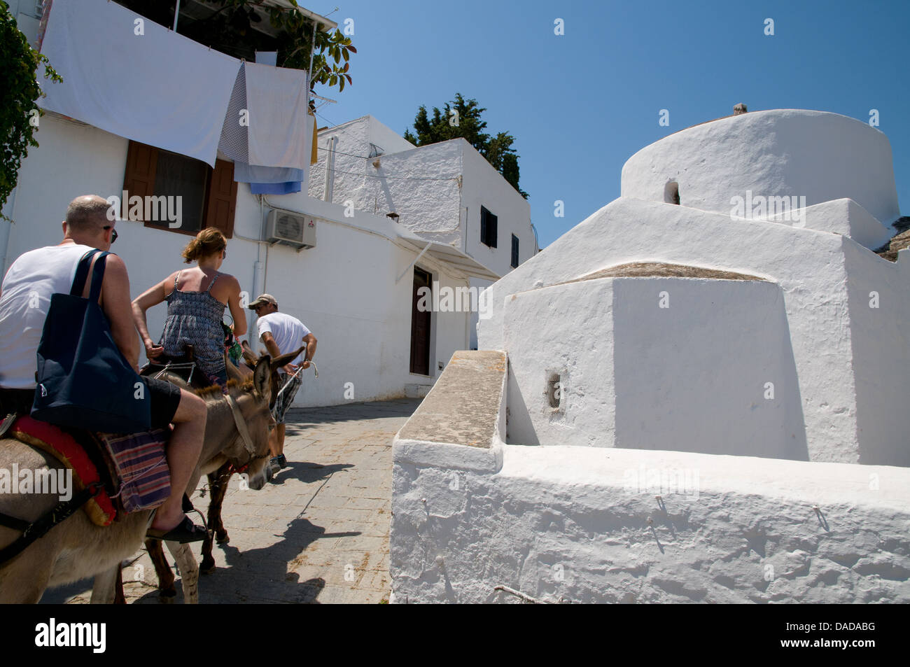 Tourists on donkeys in Lindos, island of Rhodes, Greece Stock Photo - Alamy