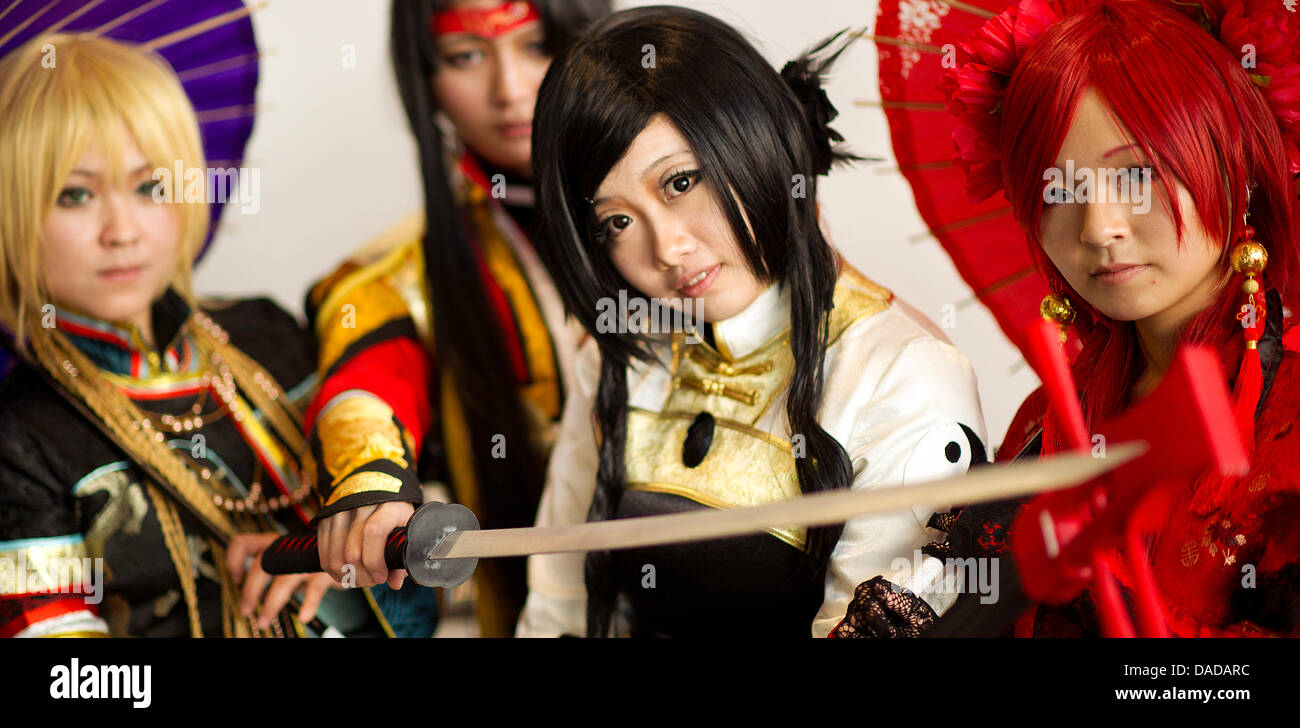 Dressed in asian costumes, fantasy fans pose for the camera at the ...