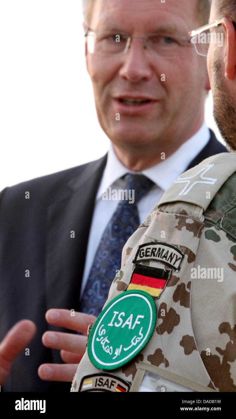 German President Christian Wulff talks to a German soldier in Masar-i ...
