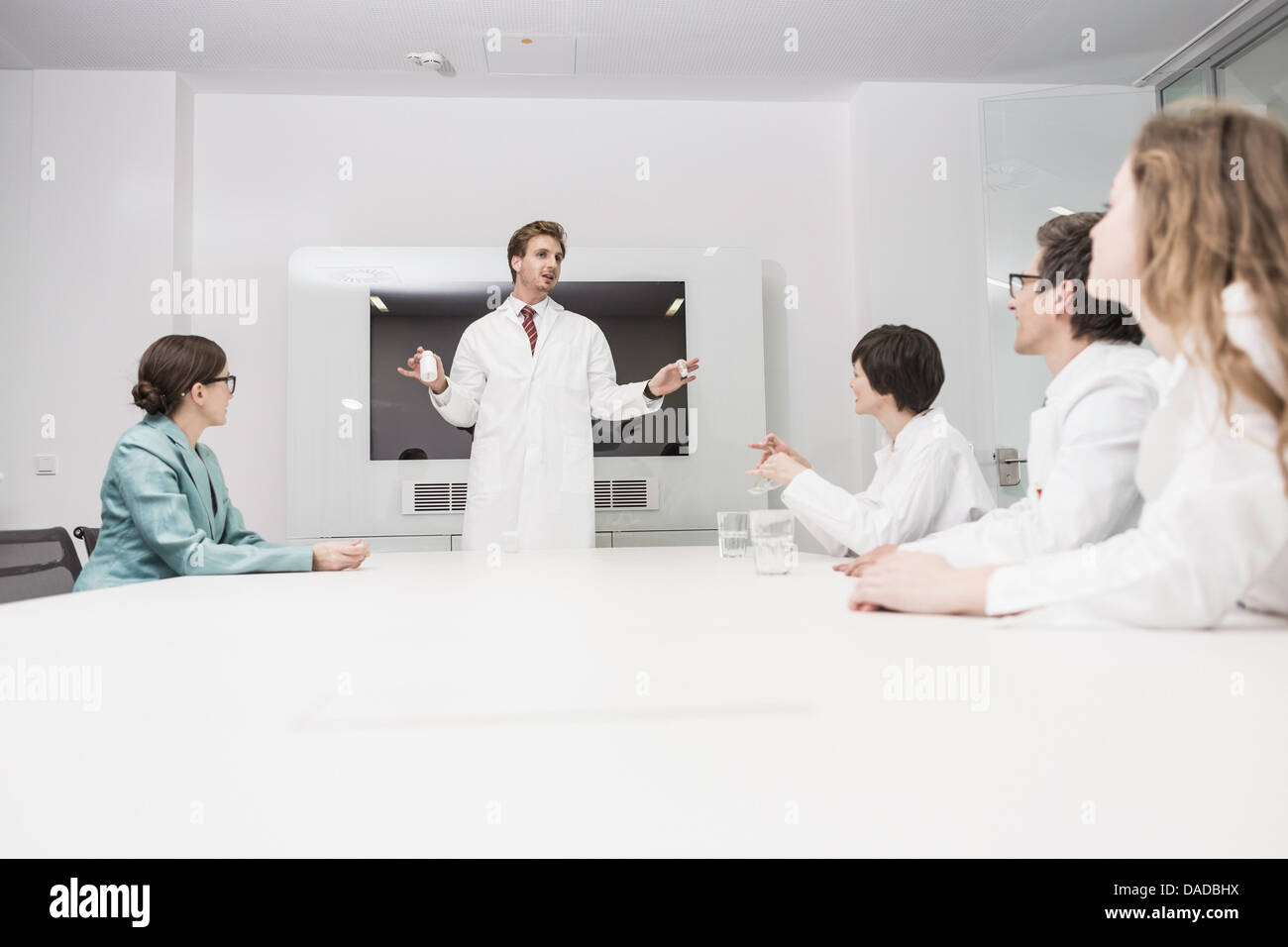 Man standing at end of conference table hi-res stock photography and ...