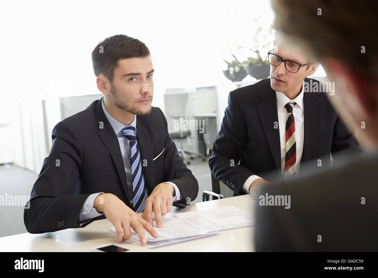 Men sitting around table hi-res stock photography and images - Alamy