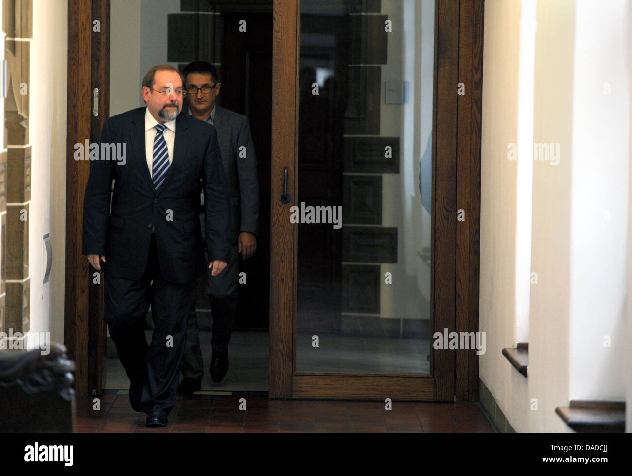 Duisburg's Mayor Adolf Sauerland (L) walks through city hall in ...