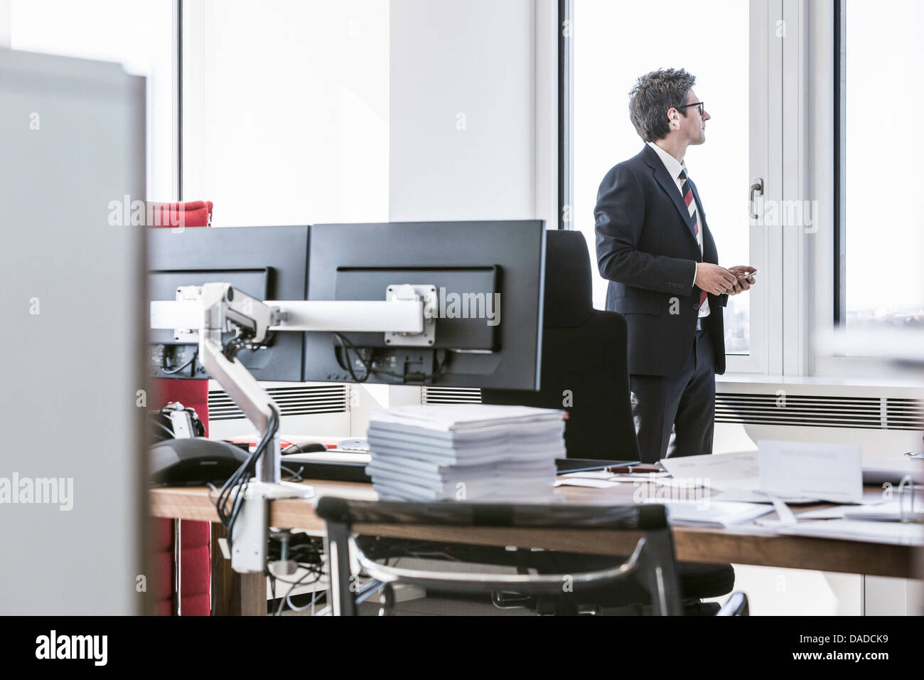 Person looking out of office window hi-res stock photography and images ...