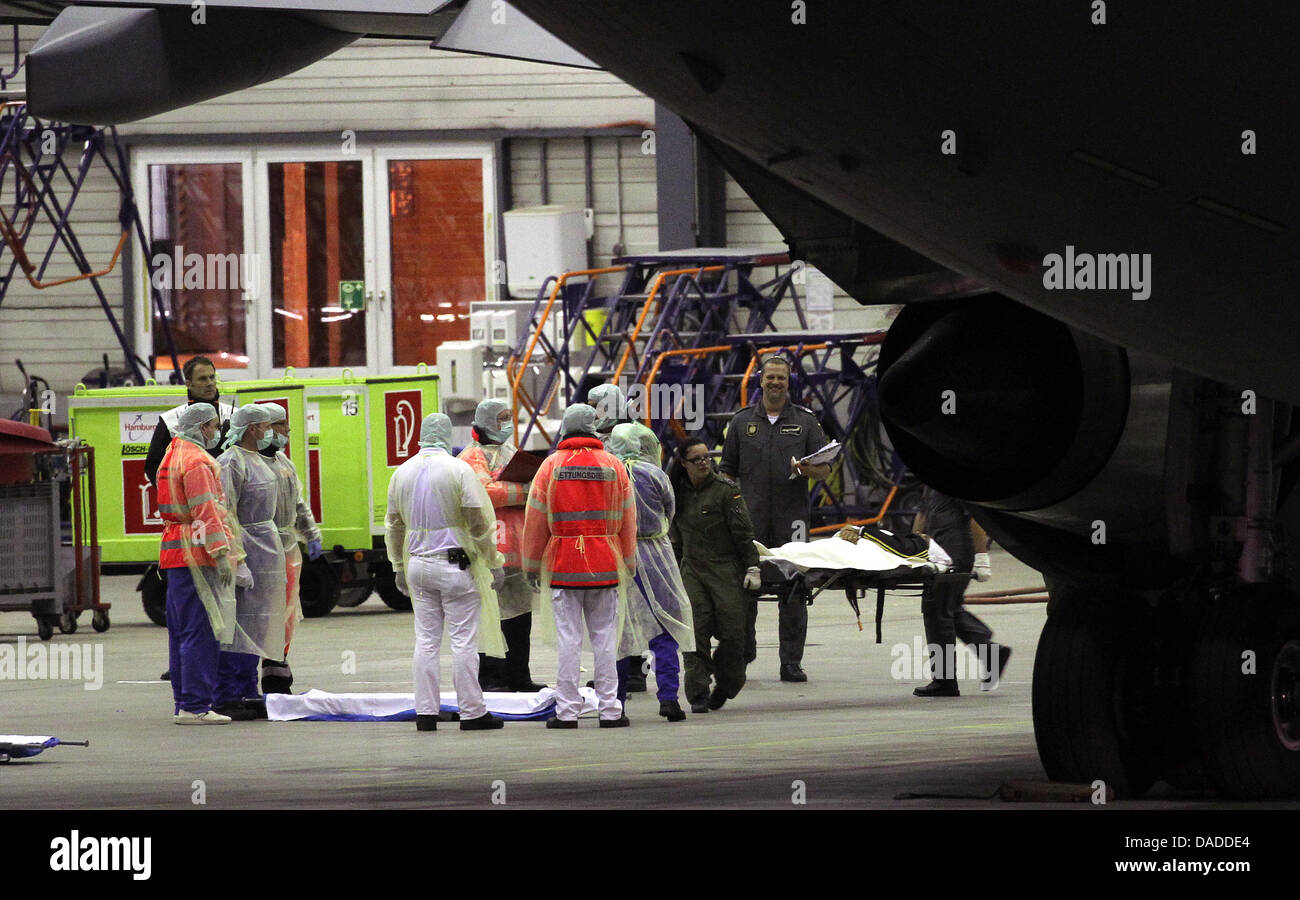 Medics and emergency doctors carry an injured Libyan citizen to an ...
