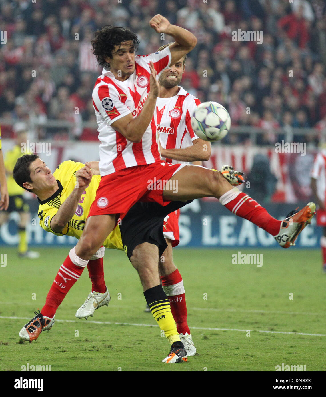 Olympiacos' Francois Modesto (R) and Robert Lewandowski (L) of Dortmund ...