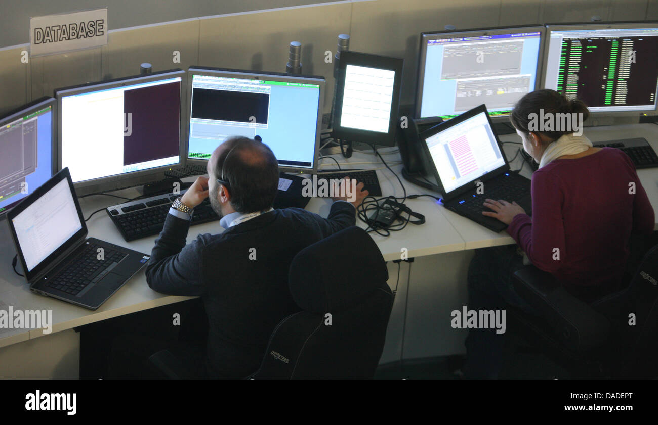 Scientists and technicians watch the launch of the first two satellites ...
