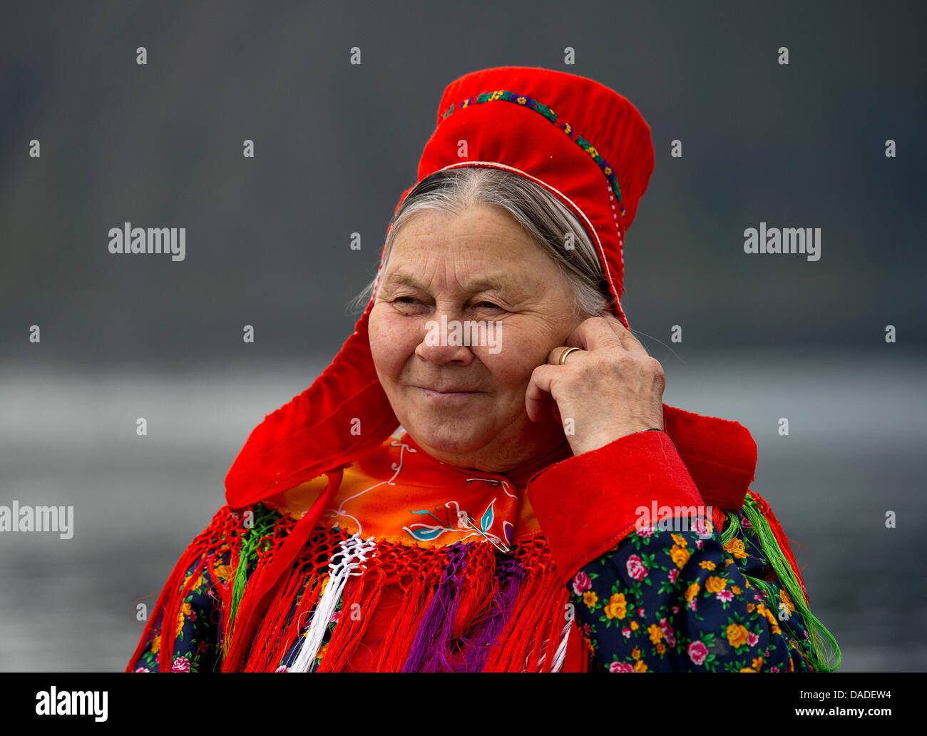 An elderly lady of the indigenous Sami people wears a traditional dress ...