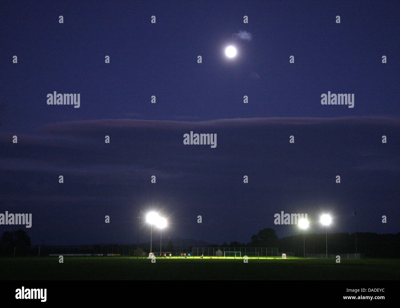 The full moon shines onto a soccer pratice session near Unterthingau ...