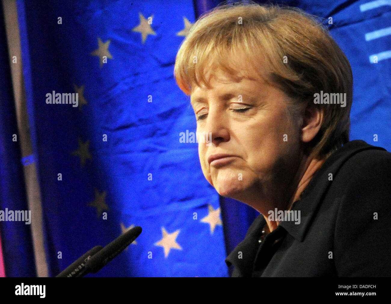 German Chancellor Angela Merkel speaks next to a European flag on ...