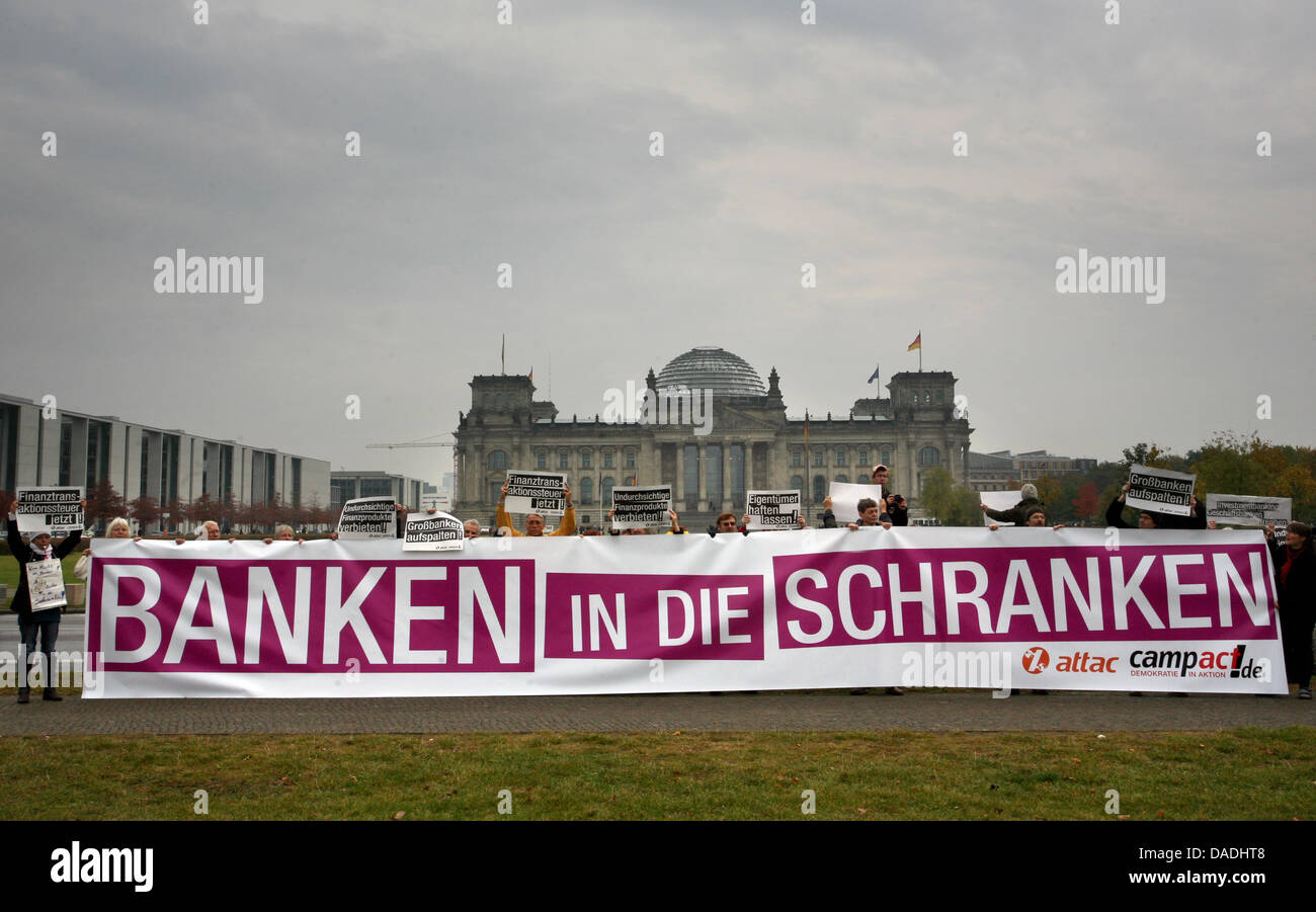 Activists from Attac and Campact protest with banners and signs in ...