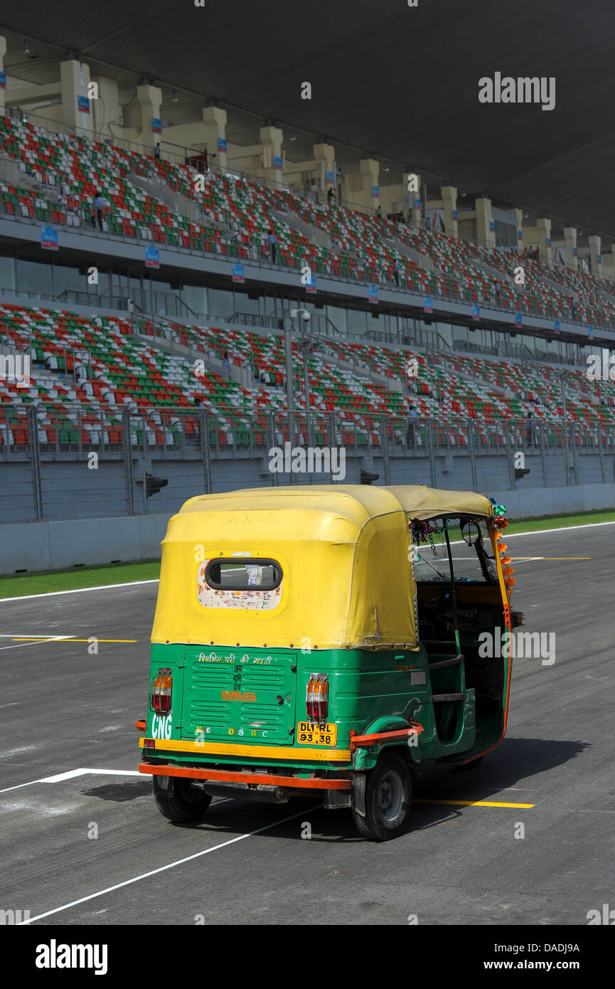 A tuk-tuk, a auto rickshaw, stands on the grid at the race track Buddh ...