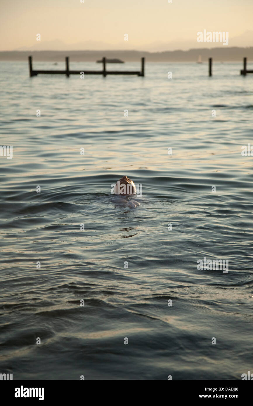 Man floating in water Stock Photo - Alamy