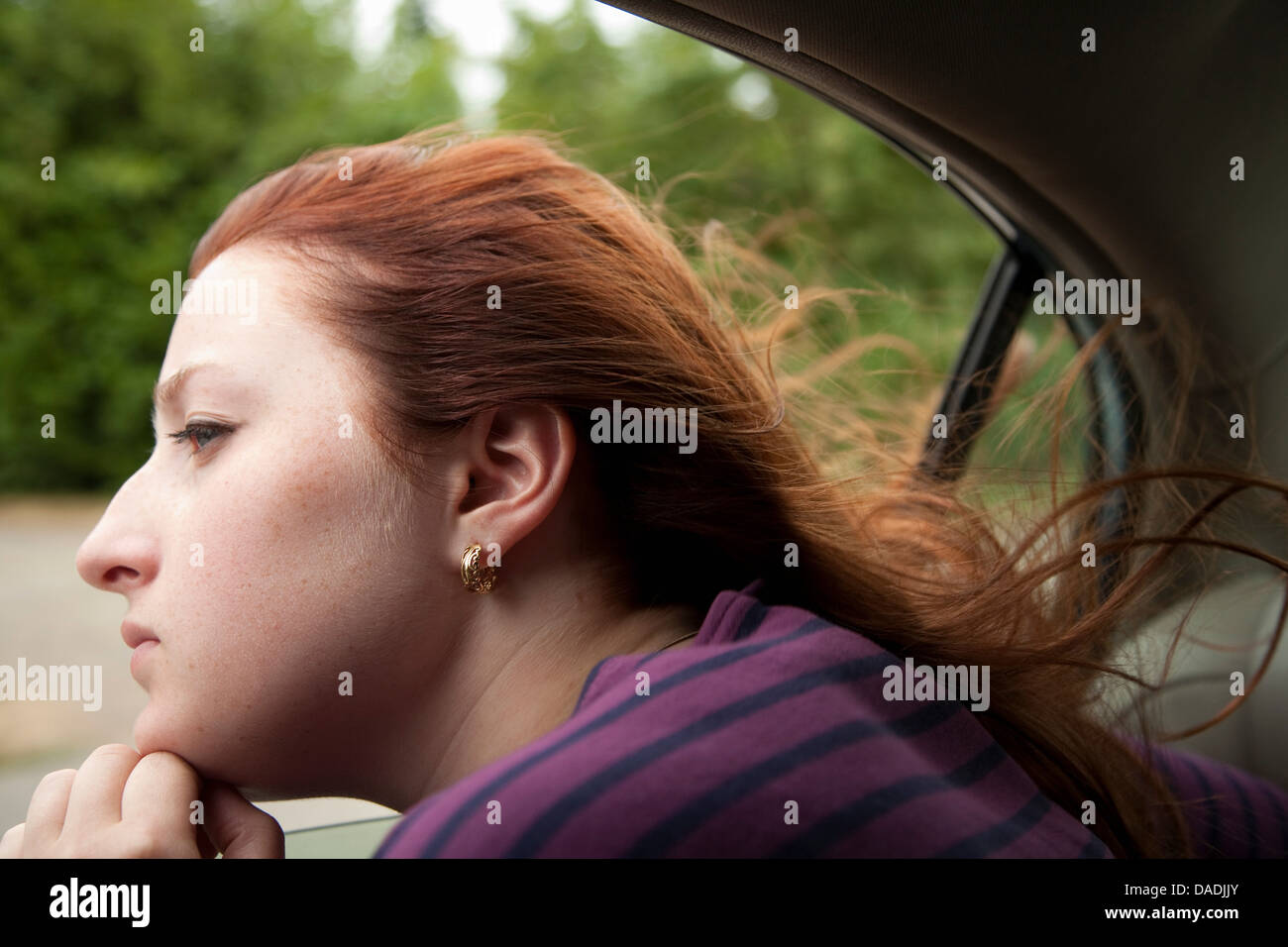 Girl looking out of car window Stock Photo - Alamy