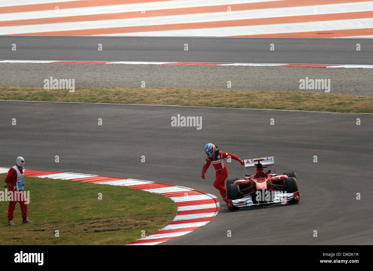 Spanish Formula One driver Fernando Alonso of Ferrari stops his car ...