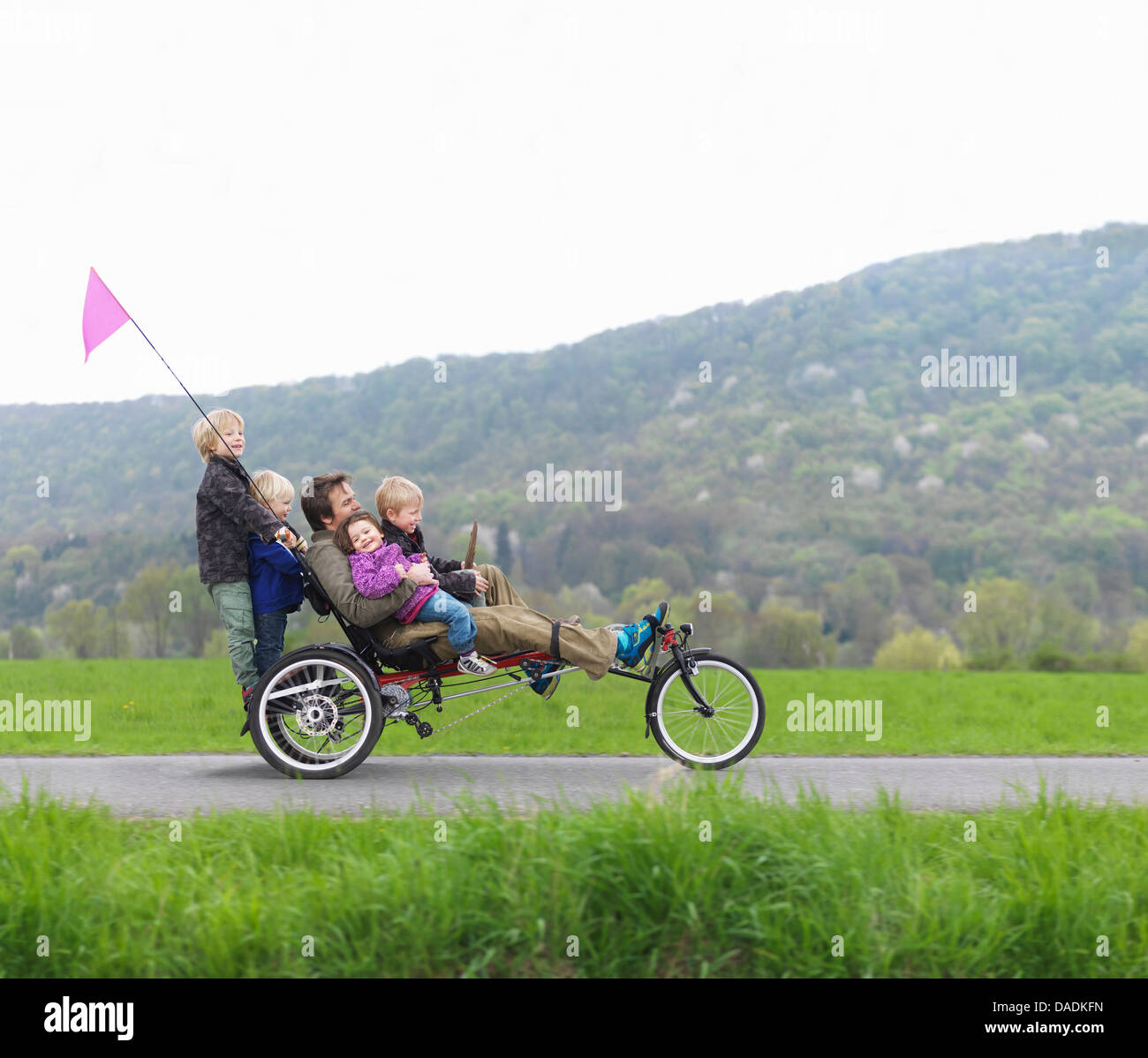 Family riding together on three wheeled bicycle Stock Photo - Alamy