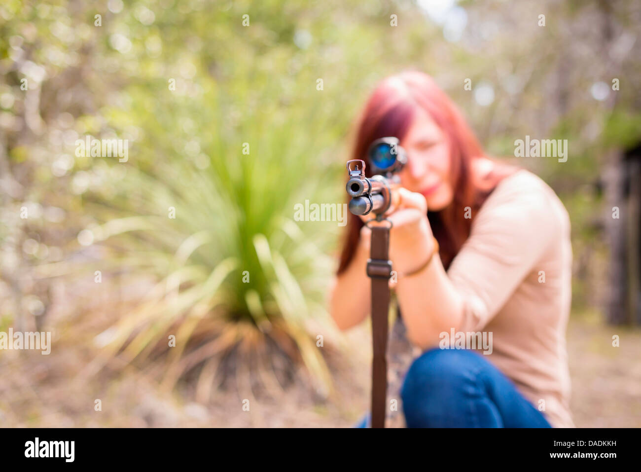 USA, Texas, Young woman aiming hunting rifle Stock Photo - Alamy