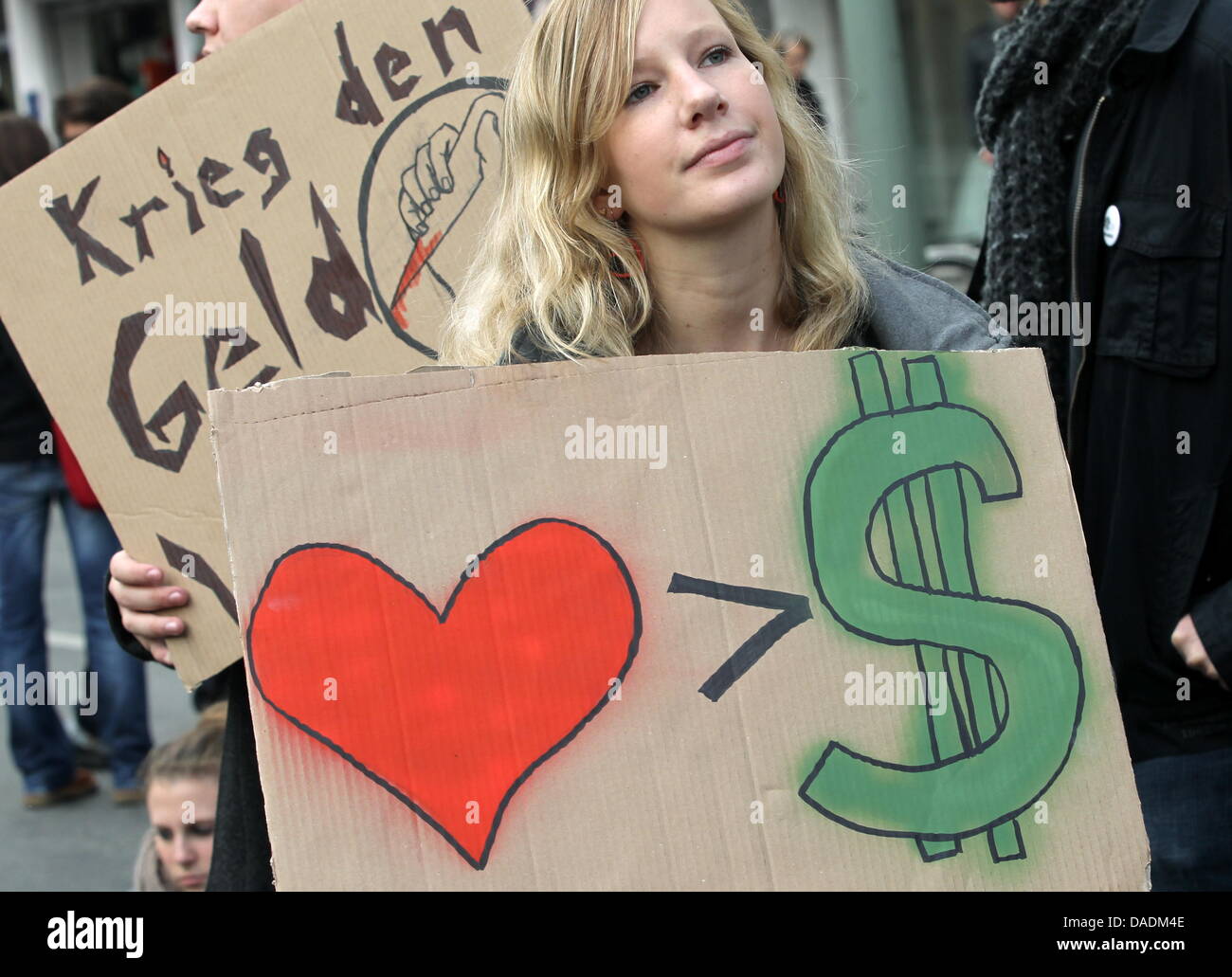 A younf female demonstrator protests against capitalism and the bank's ...