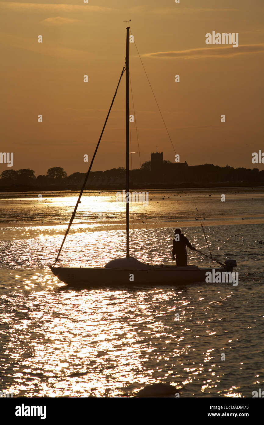 boating in the sunset - silhouetted in the sunlight at Hengistbury Head ...