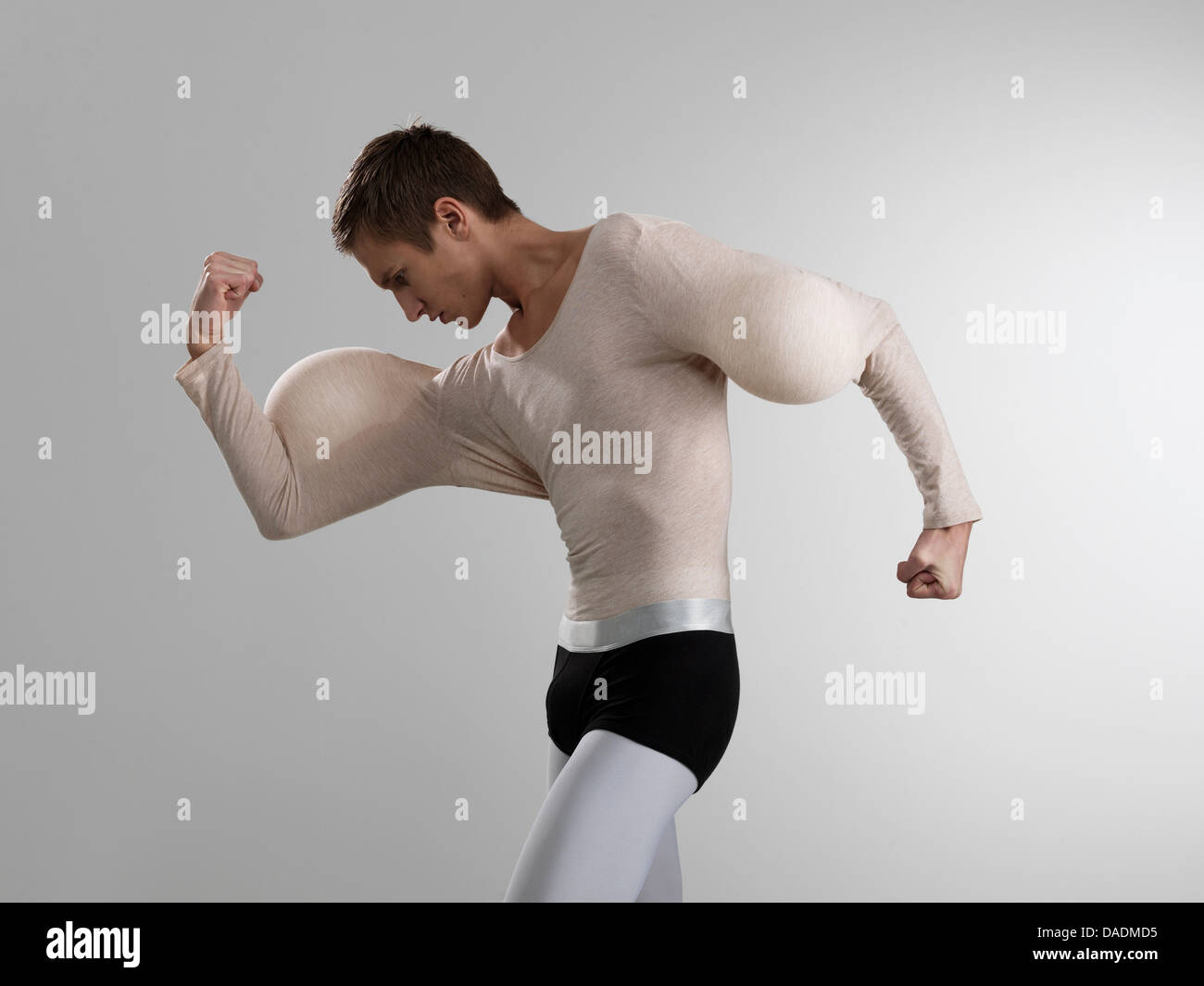 Man flexing muscles with balloons in sleeves Stock Photo - Alamy