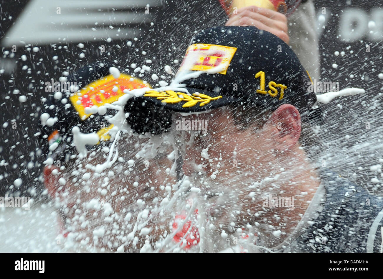 German Formula One driver Sebastian Vettel of Red Bull (R) gets a ...