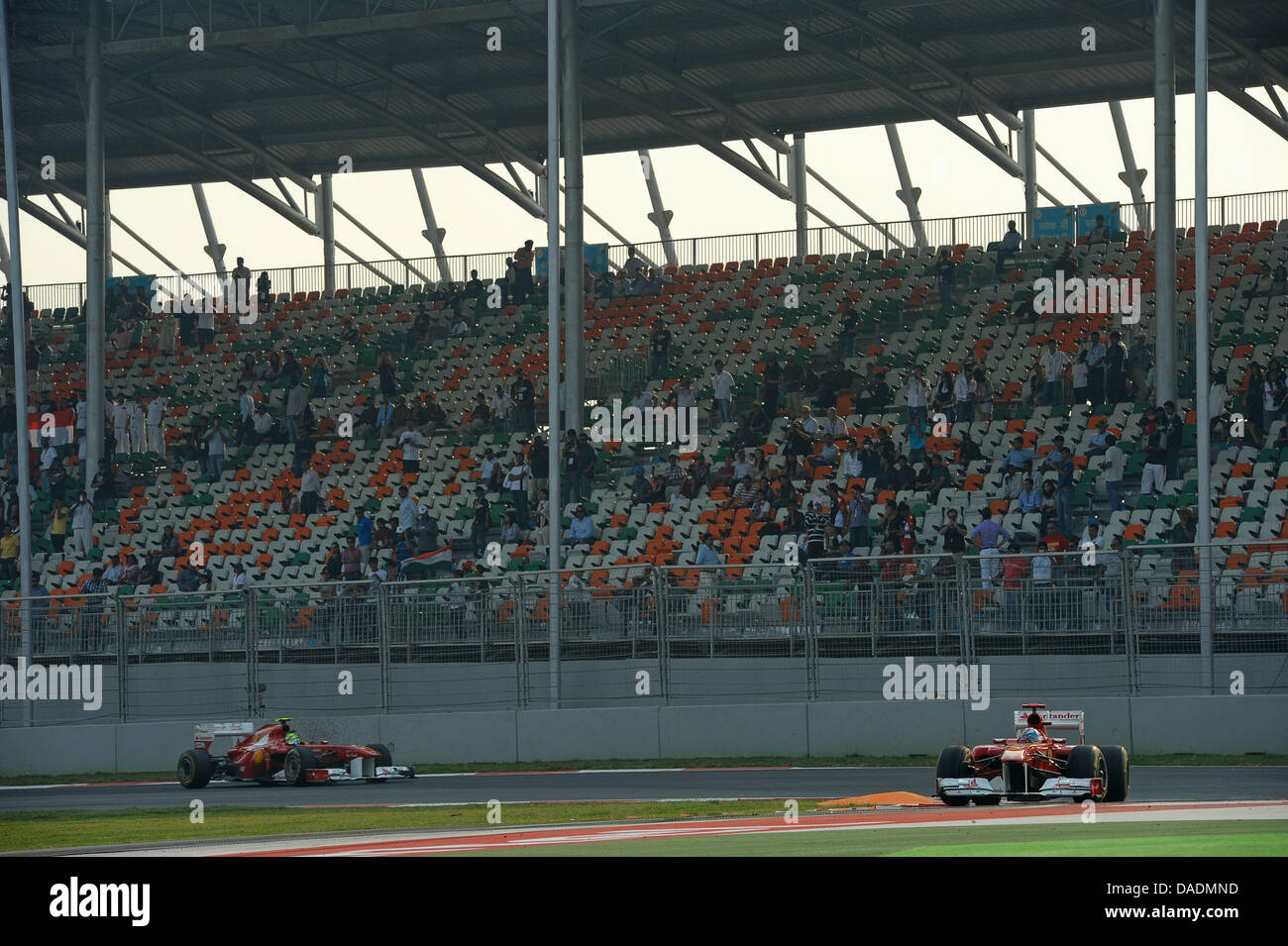 Spanish Formula One driver Fernando Alonso (R) of Ferrari steers his ...