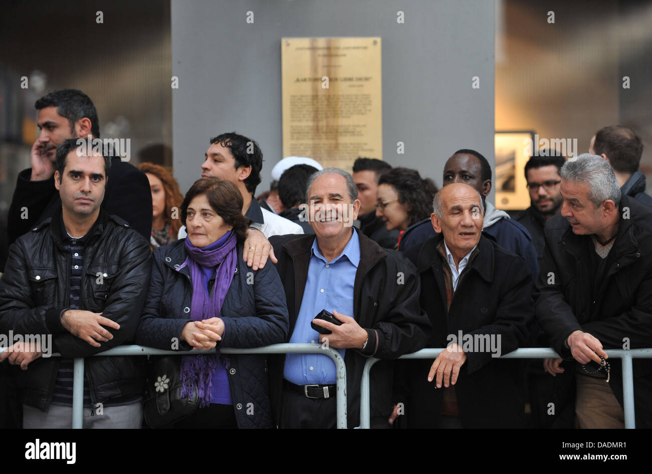 German-Turkish citizens stand in front of a memorial plaque while they ...