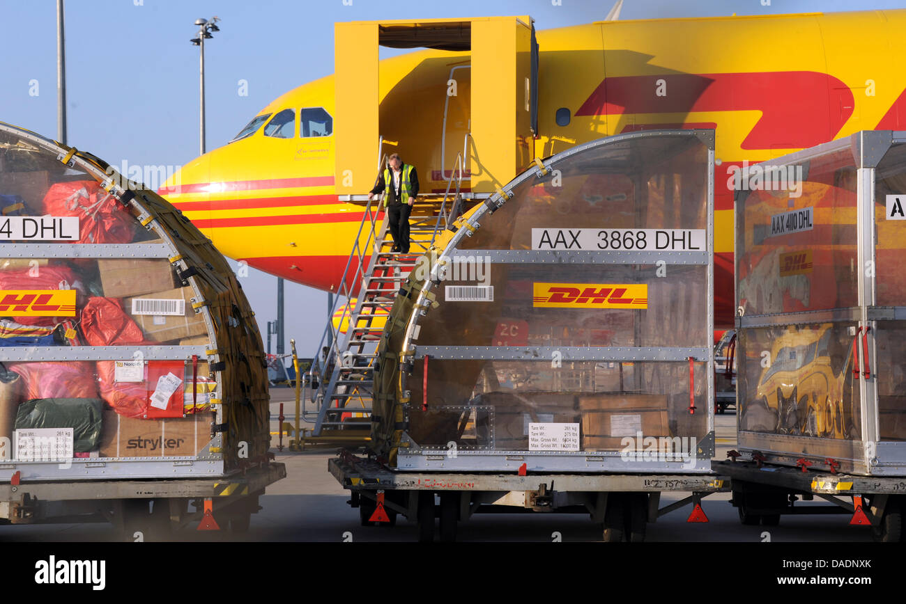 A cargo plane of the mail service DHL is loaded at the airport Leipzig ...