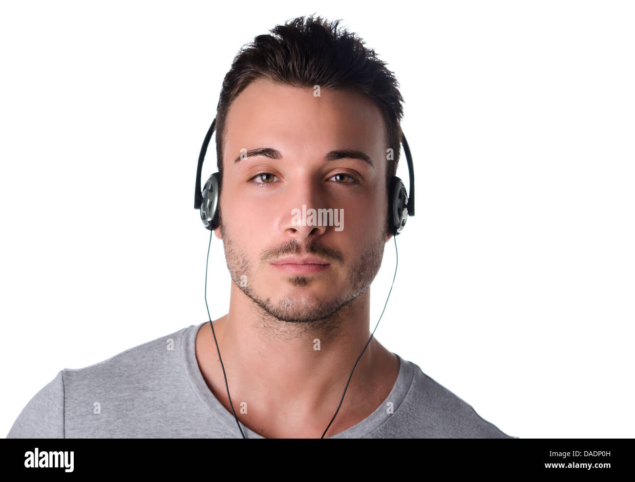 Handsome young man with headphones listening to music, isolated on ...