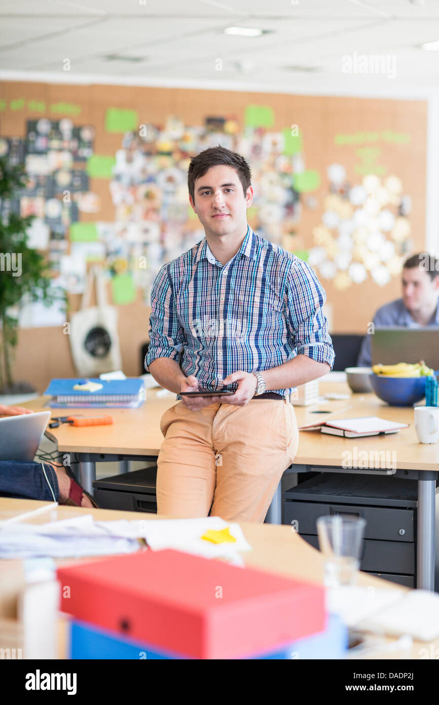 Young man in creative office, portrait Stock Photo - Alamy