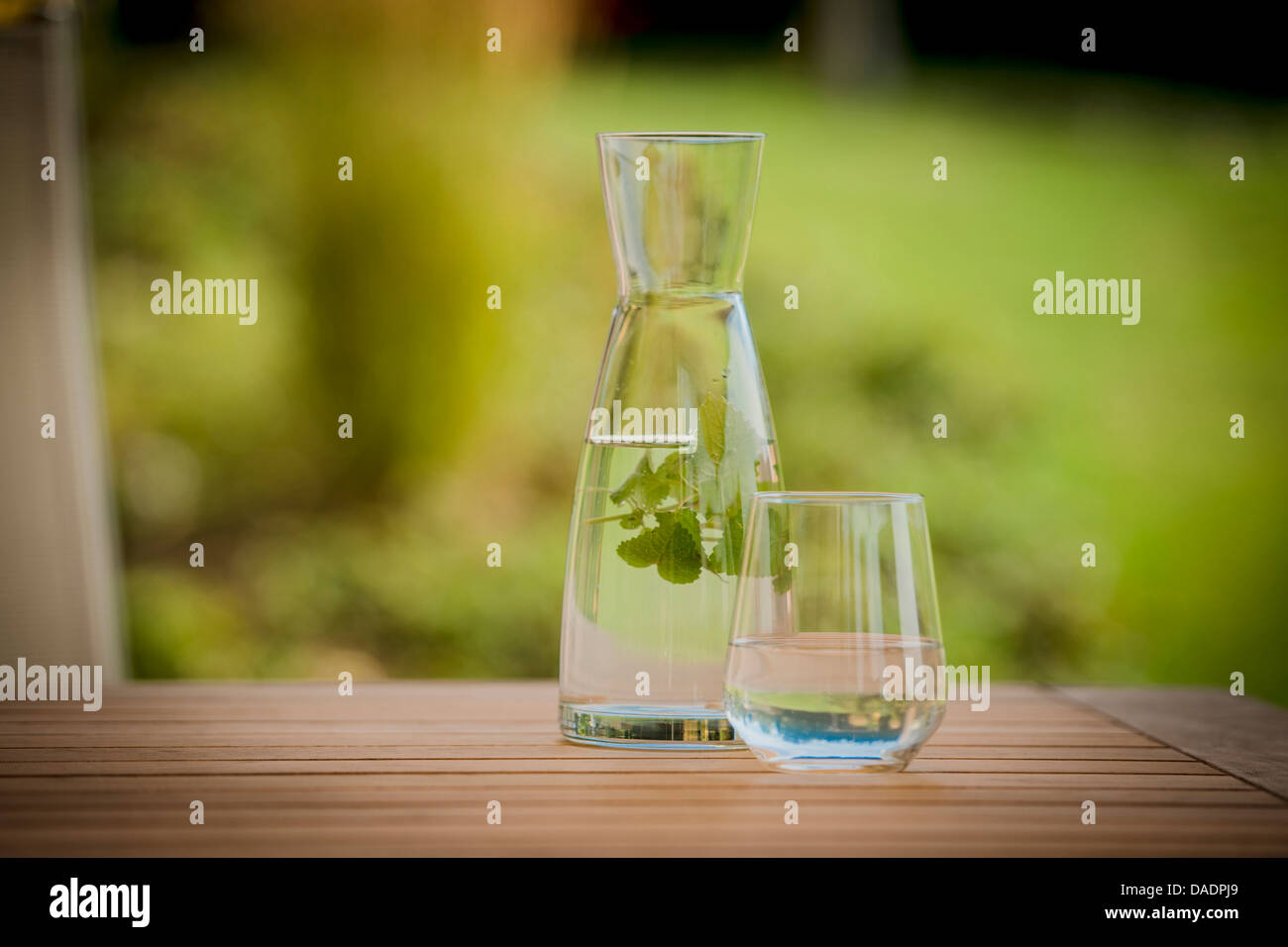 water carafe with fresh herbs and drinking glass Stock Photo - Alamy