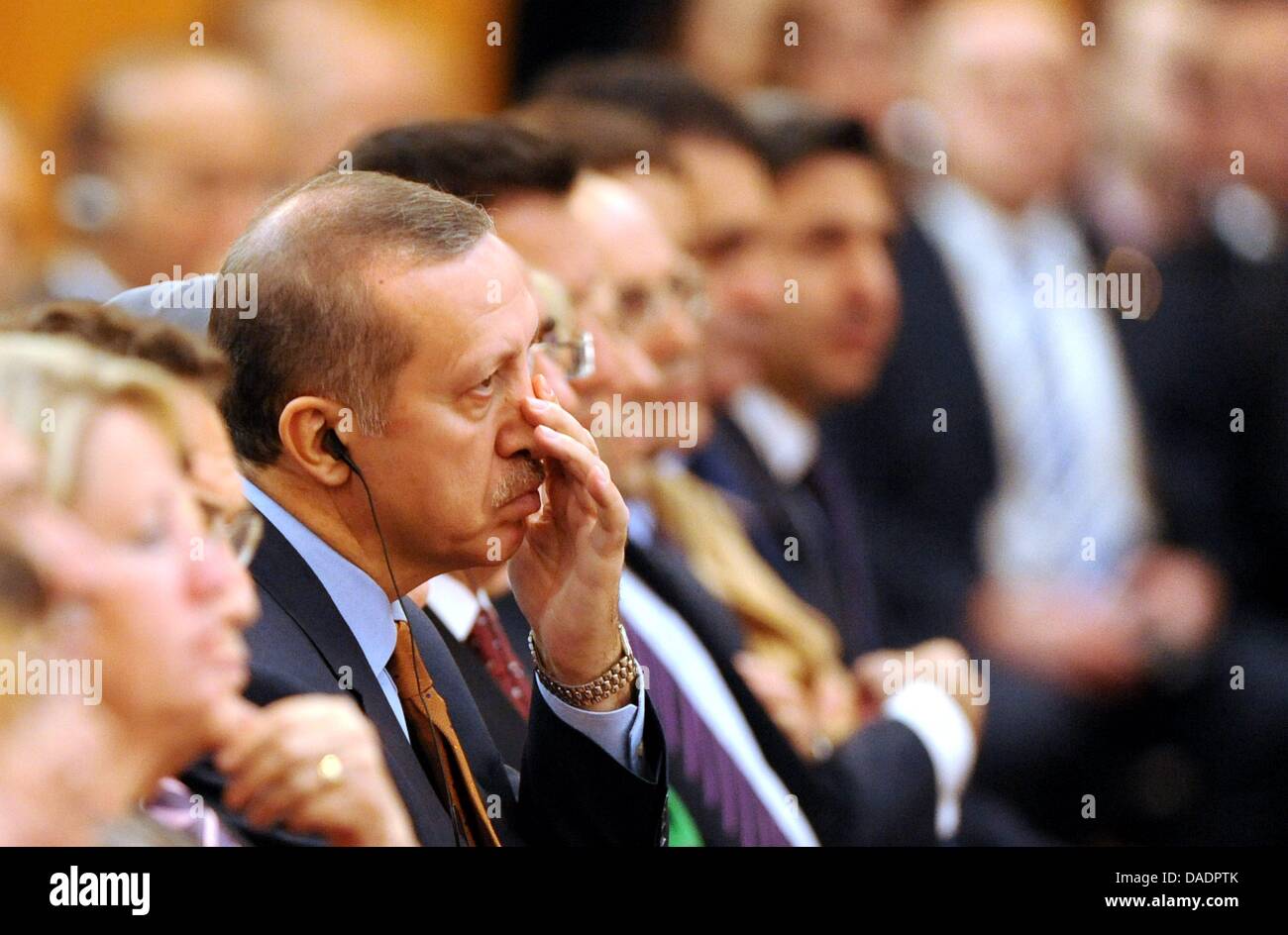 Turkish Premier Recep Tayyip Erdogan follows the speech during a ...