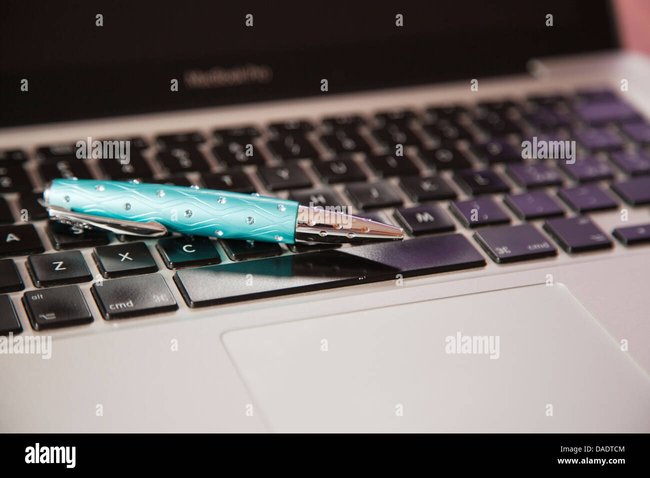 pen on the laptop Stock Photo - Alamy