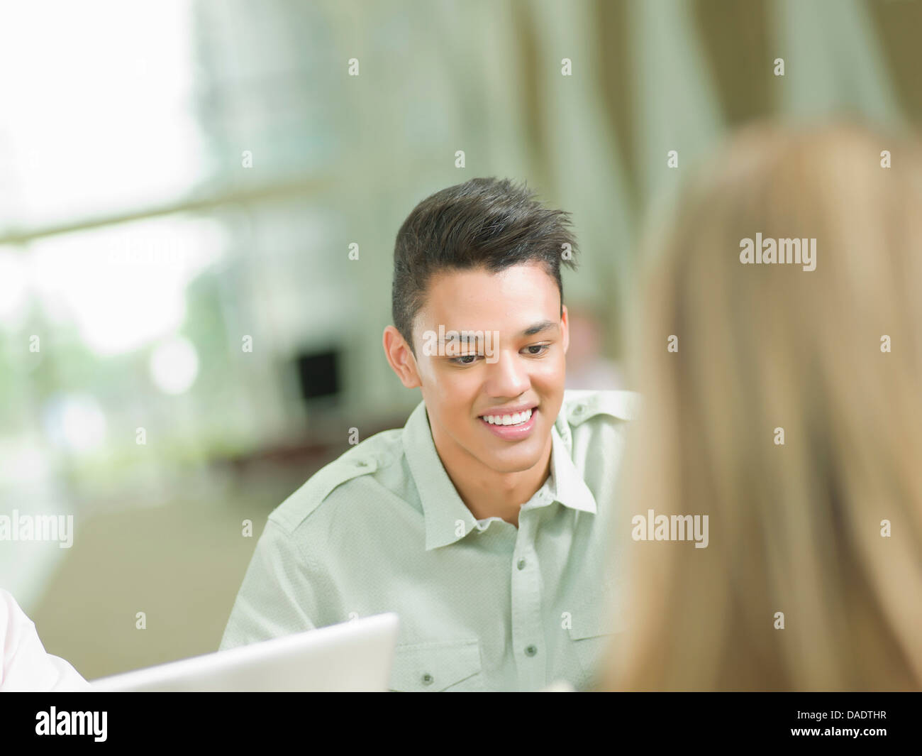 Young man studying and smiling Stock Photo - Alamy Young man studying and smiling Stock Photo - Alamy