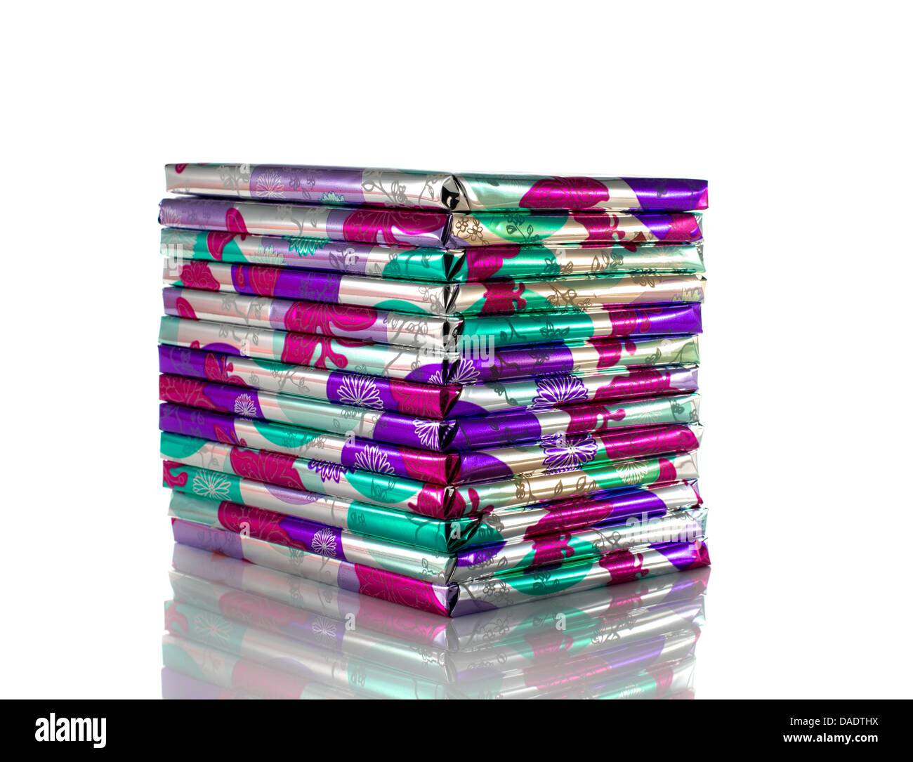 stack of presents in pink silver and green isolated on white background ...