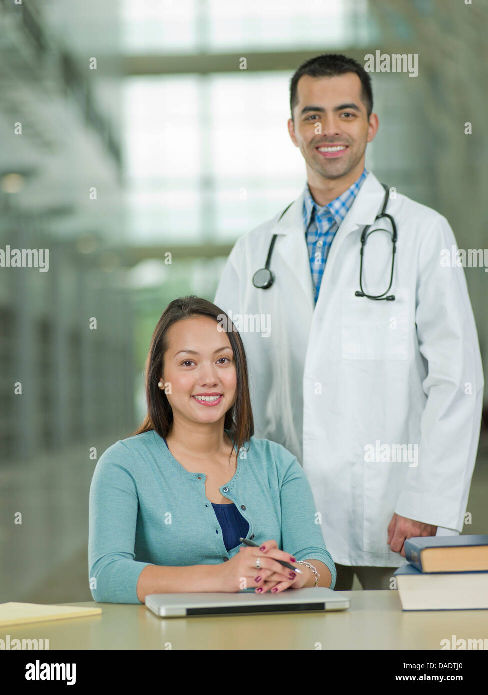 Mid adult doctor and young student smiling, portrait Stock Photo - Alamy