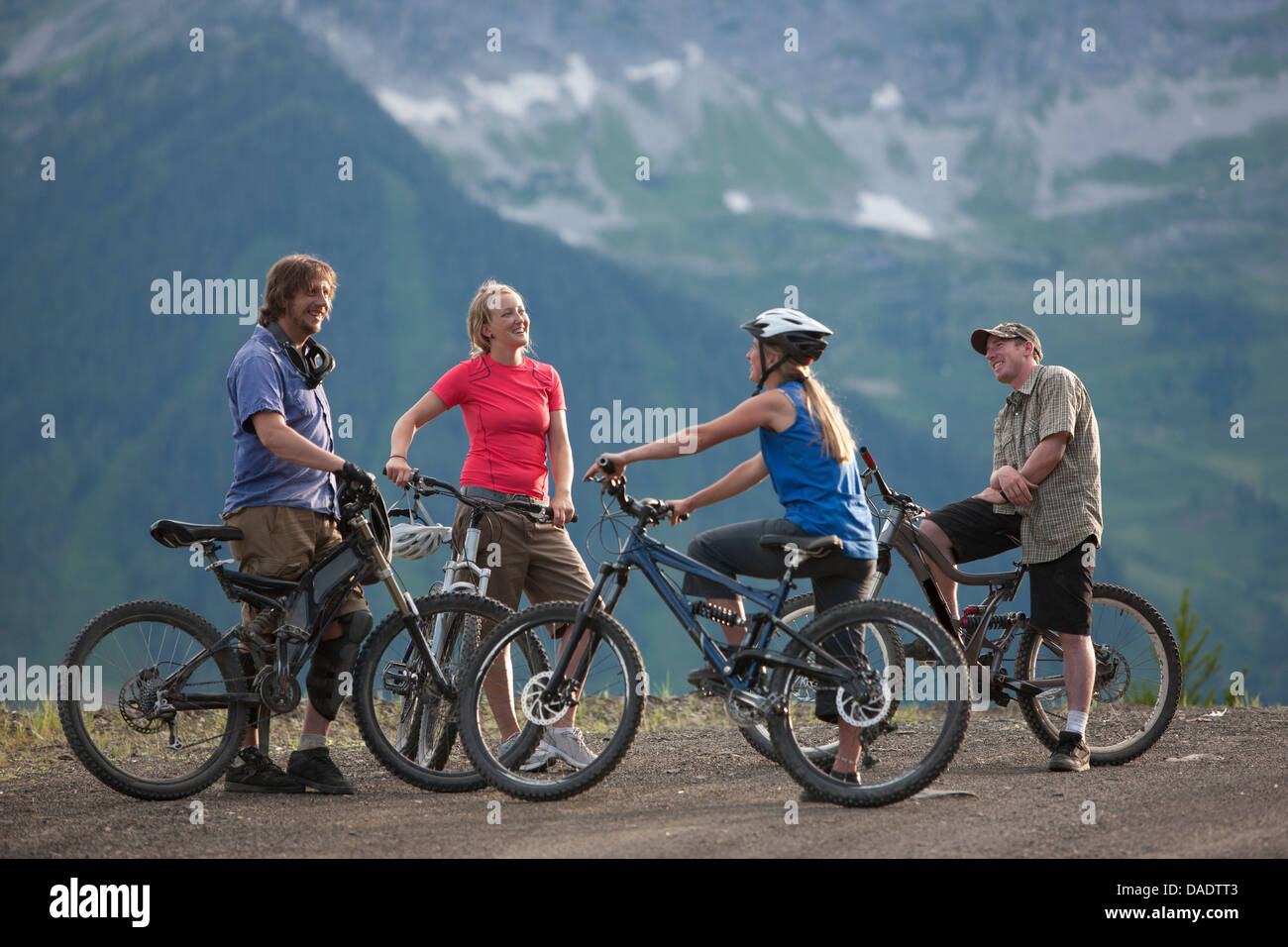 Four friends mountain biking together Stock Photo - Alamy