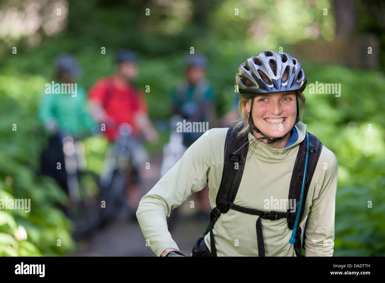 Female cyclist smiling Stock Photo - Alamy