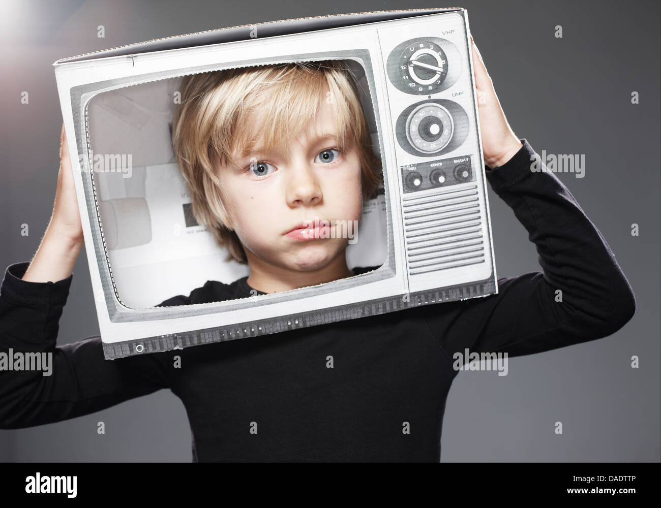 Portrait of sad boy head in paper TV against grey background Stock ...