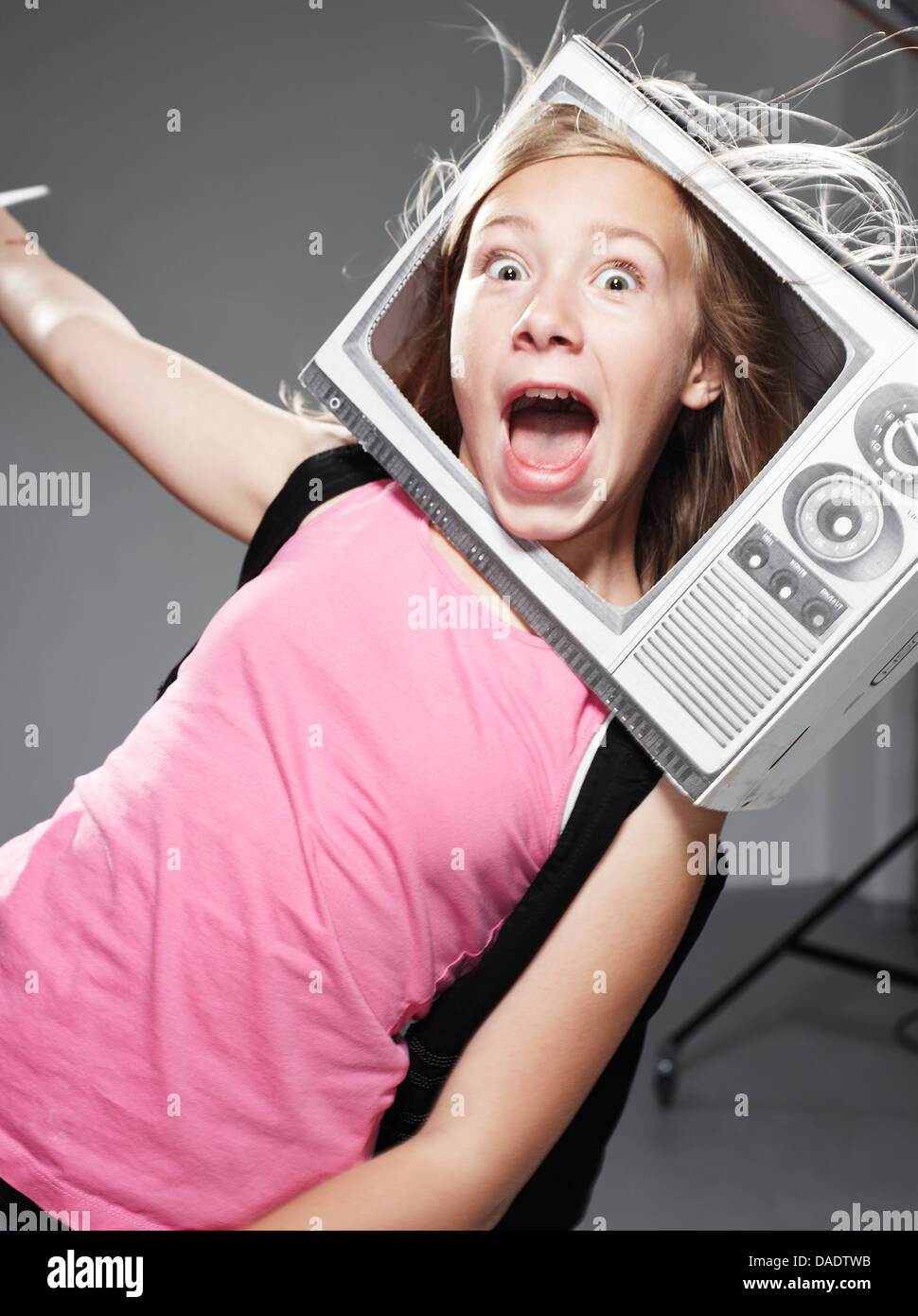 Girl screaming in paper TV against grey background Stock Photo - Alamy