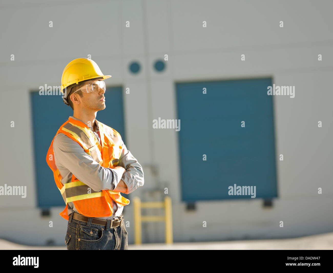 Mid adult construction worker with arms folded Stock Photo - Alamy
