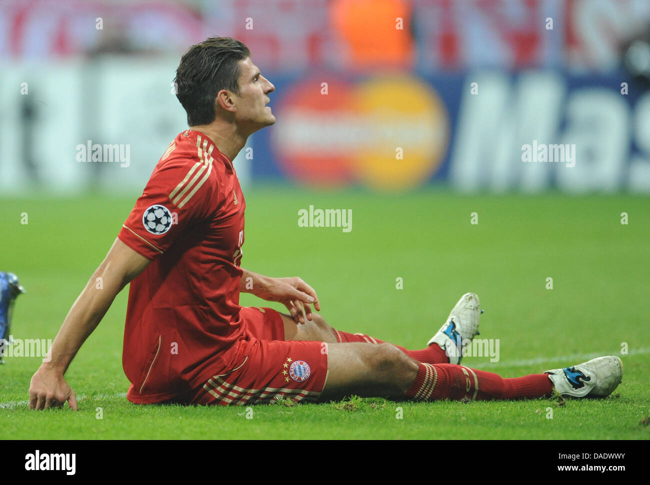 Bayern Munich's Mario Gomez sits on the pitch during the Champions ...