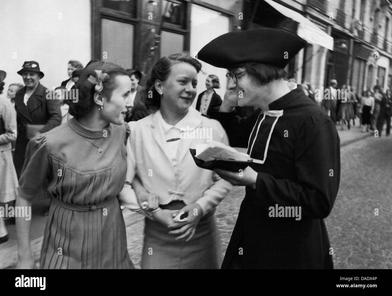 France, 1935, two women talking to a costumed man. Image by ...