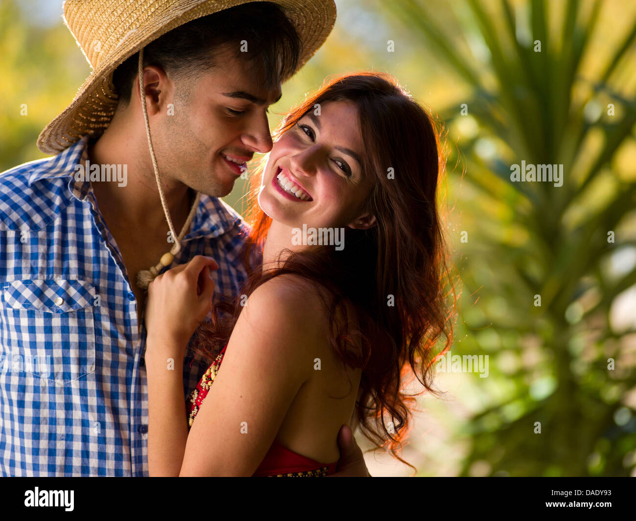 Young man embracing smiling woman, portrait Stock Photo - Alamy