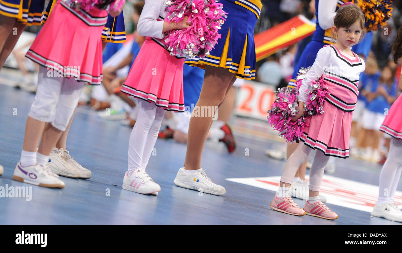 A small cheerleader makes a face before the Handball Supercup match ...
