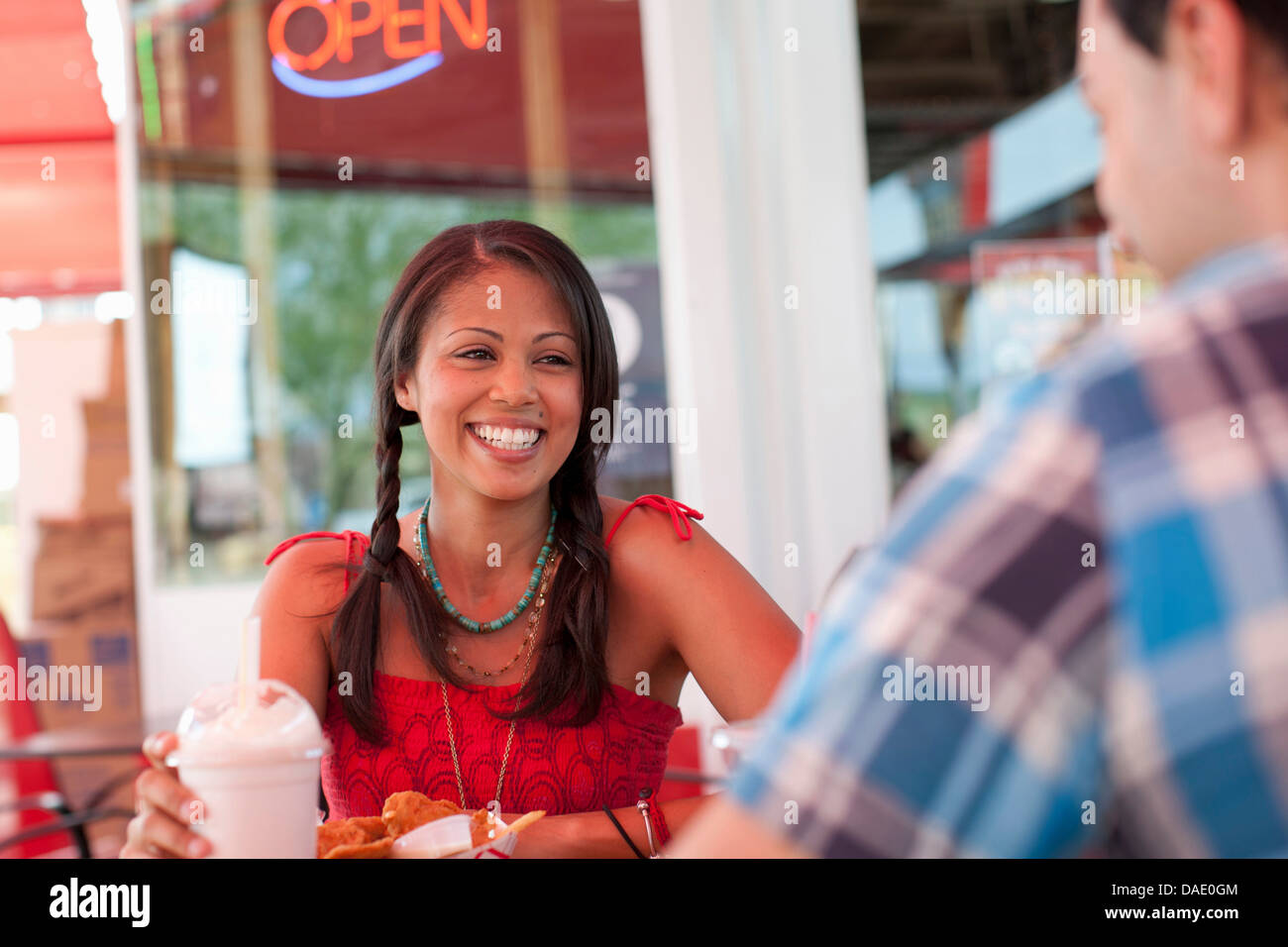Young woman in diner, smiling Stock Photo - Alamy