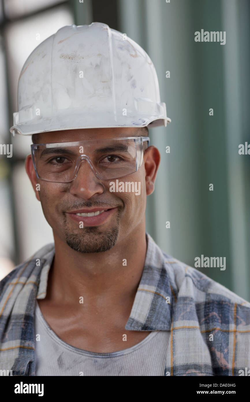 Mid adult construction worker wearing hard hat, portrait Stock Photo ...